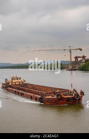 SOUTH GOA, INDIA - May 05, 2020: Barges carrying mining ore for export ...