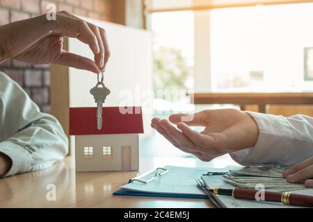 Salesman home brokers provide key to new homeowners in office Stock ...