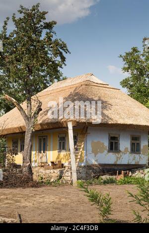 Traditional moldovian rural house. House is under roofing from bulrush ...