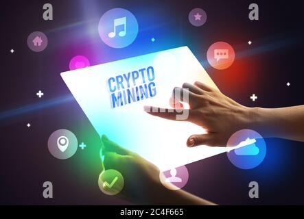 Holding futuristic tablet with CRYPTO MINING inscription, new ...