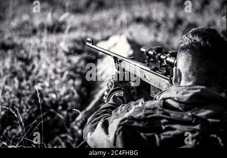 Hunter man. Hunting period. Male with a gun, rifle. Man is charging a ...