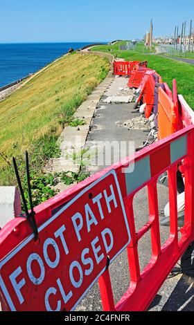 Damaged fence on cliff edge Stock Photo - Alamy