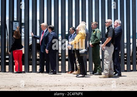 Arizona Gov. Doug Ducey, left, smiles as he shakes hands with son Jack ...