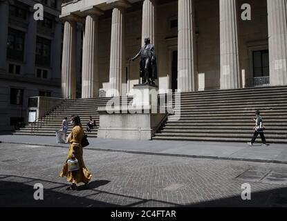 Pedestrians walk on a Black Lives Matter mural painted in front of ...