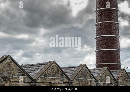 Old-style mill factory showing the individual roof structures. A large ...
