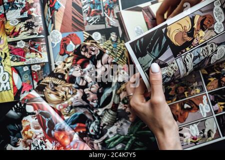 Hand flipping through comic book pages Stock Photo - Alamy