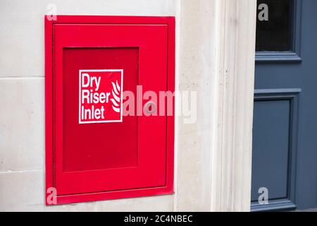 Dry riser red inlet box and sign at wall Stock Photo - Alamy