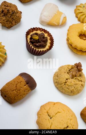 Vertical shot of different kind of cookies isolated on a white ...