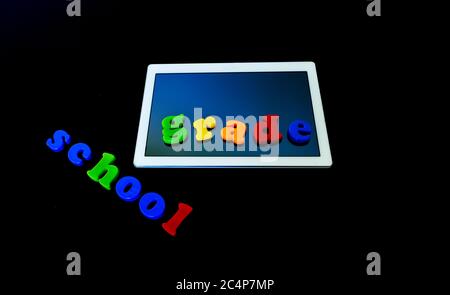 Tablet with the inscription FIRST GRADE. Tablet PC, technology and ...