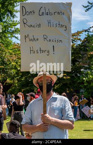 A protestor holds a placard during the demonstration. A protest was ...