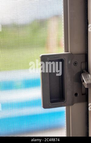 Interior sliding screen door hardware and flip latch Stock Photo - Alamy