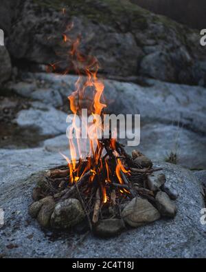 A vertical shot of a small bonfire burning in a metal container Stock ...