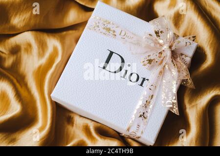 Gift box from DIOR with makeup on a golden fabric Stock Photo - Alamy