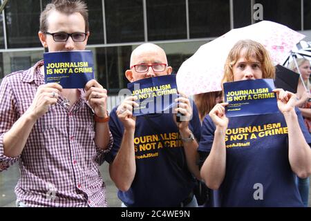 Protesters hold signs saying ‘Journalism is not a crime’ at the rally ...