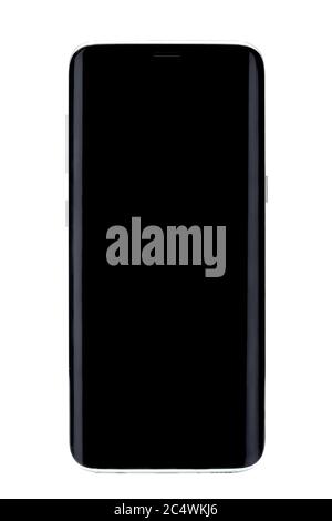 Modern smart phone with round edges on white desk. Isolated screen for ...