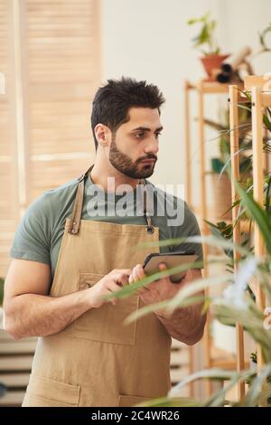Arab man with beard working at small business ecommerce holding bitcoin ...