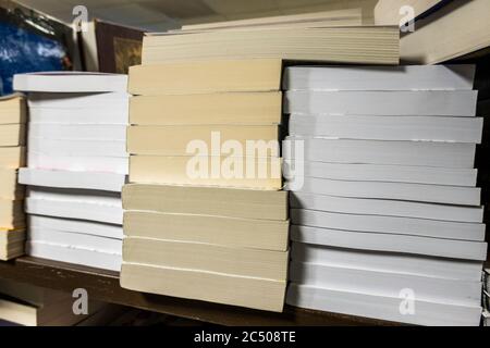 stacks of paperbacks on a shelf Stock Photo - Alamy