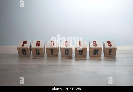 Wooden blocks turning over from outcome to journey Stock Photo - Alamy
