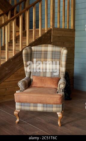 A grey modern cozy armchair in a living room Stock Photo - Alamy