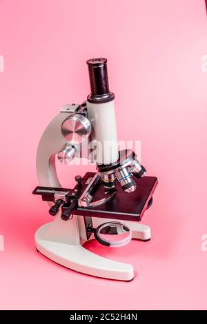 Metal microscope on pink base Stock Photo - Alamy