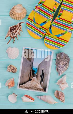 Flat lay composition with flip flops and seashell on colored background ...