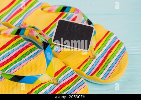 Bright women's flip flops on a wood board Stock Photo - Alamy