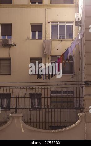 Vertical shot of laundry hanging from balconies in the streets of ...