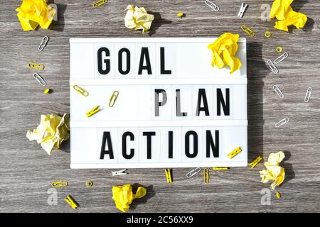 lightbox with text GOAL PLAN ACTION on wooden background, copy space ...