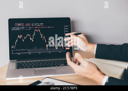 Two investors are working together with analyzing the stock data graphs ...