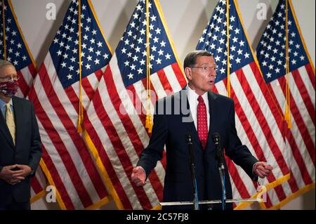 Sen. John Barrasso, R-Wyo., left, returns to the Senate floor on ...