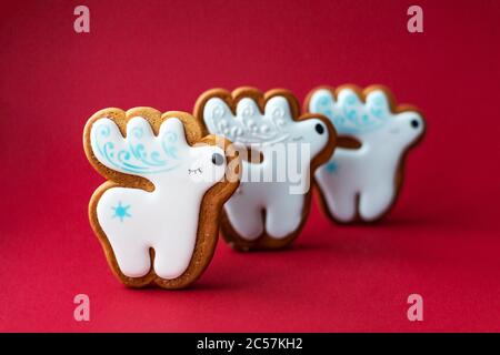 gingerbread cookie of little cute deer on red background. Traditional ...