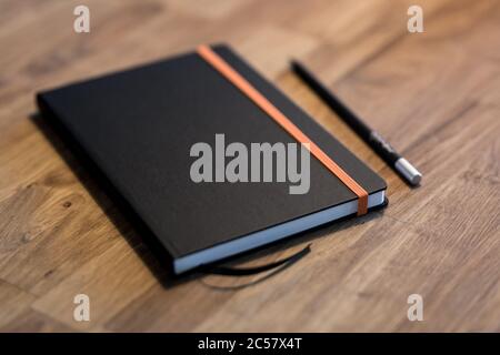 notepad with small pencil on vintage wooden table Stock Photo - Alamy
