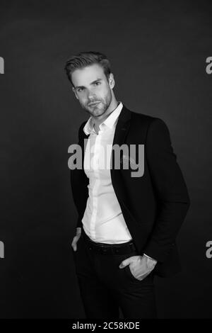 Remaining conservative in style. Stylish businessman dark background ...