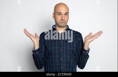 Confused bald man isolated on white studio background Stock Photo - Alamy