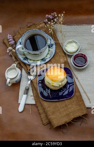 Scones served with black coffee with milk on sack cloth for new morning ...