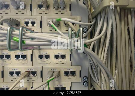 Closeup shot of many complicated electronic wires on the white wall ...