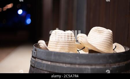 Closeup shot of two cowboy hats on the table surrounded by people Stock ...
