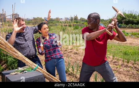 Angry neighbors quarrel on the border of the garden Stock Photo - Alamy
