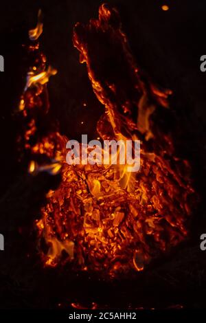 Closeup of embers of a burning log creating a fiery background Stock ...