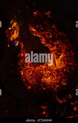 Closeup of embers of a burning log creating a fiery background Stock ...