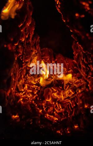 Closeup of embers of a burning log creating a fiery background Stock ...
