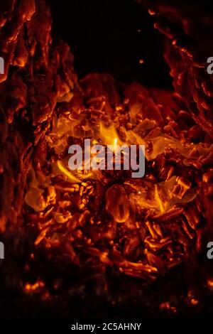Closeup of embers of a burning log creating a fiery background Stock ...