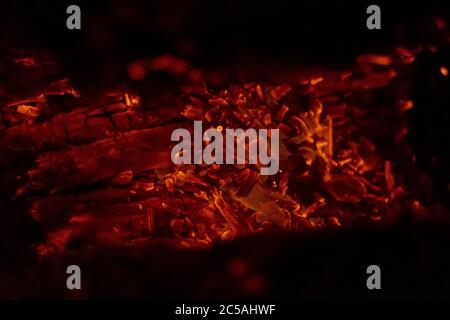 Closeup of embers of a burning log creating a fiery background Stock ...