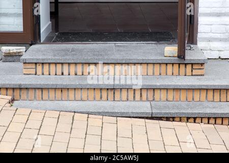 brick threshold with granite steps to the front door, close-up of the ...
