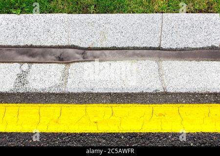 storm water channel concrete gutter with precipitation on the roadside ...