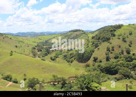 Closeup shot of a mountainous green field with random trees - perfect ...