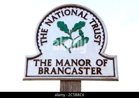 The Manor of Brancaster and National Trust sign on the green at ...
