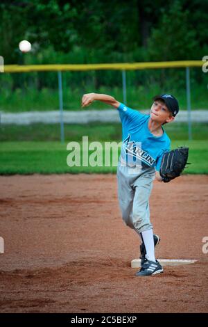 Little League baseball pitcher throwing baseball Stock Photo - Alamy
