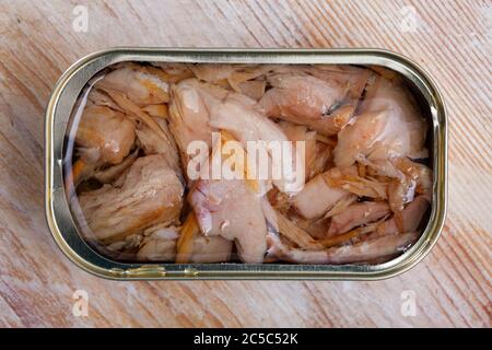 Tuna belly slices in oil in tin can with greens and lemon Stock Photo ...