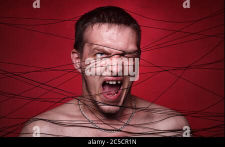 Crazy screaming red man on a red background. figure in a leotard ...
